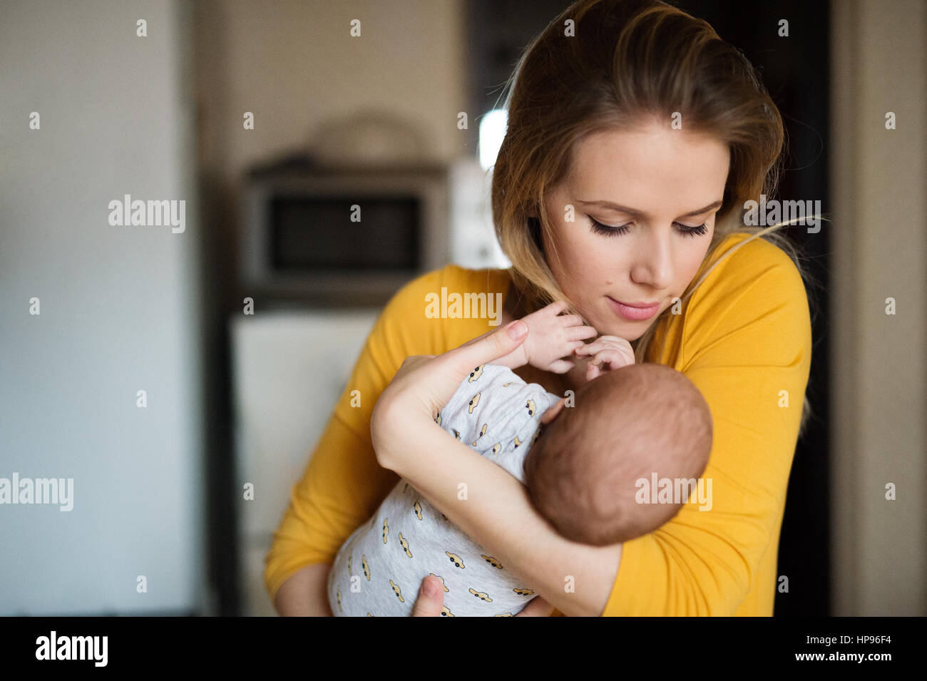 Beautiful young mother holding baby son in her arms Stock Photo - Alamy Beautiful young mother holding baby son in her arms Stock Photo - Alamy