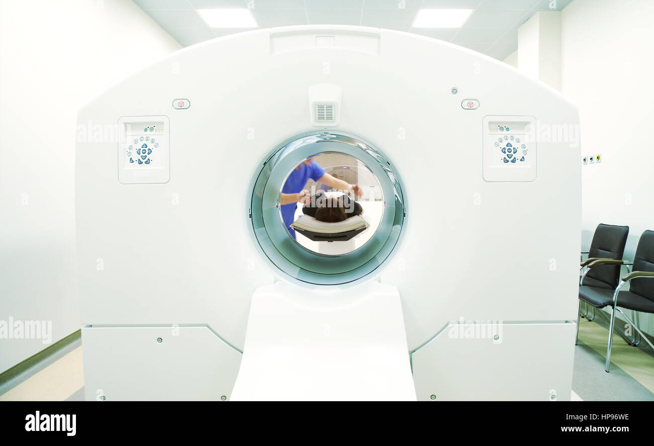 A patient being prepared for MRI x-ray scan in modern hi-tech hospital ...