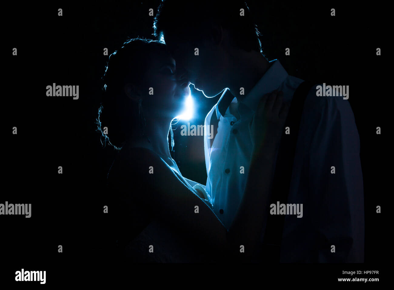 Loving couple backlit with a blue light. Studio photo Stock Photo - Alamy