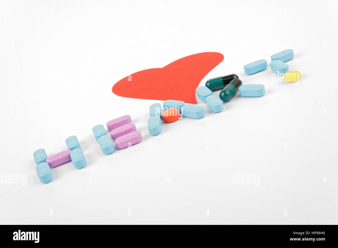 Medicine pills and red heart shape on white background as health care ...