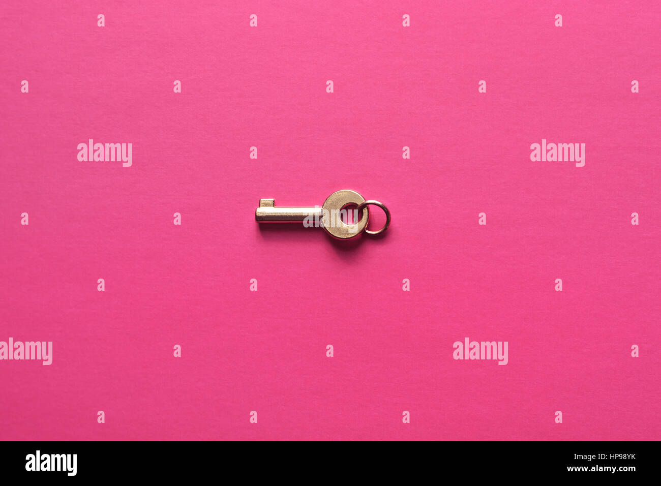 Golden key on a pink background, top view. Trendy colorful photo ...