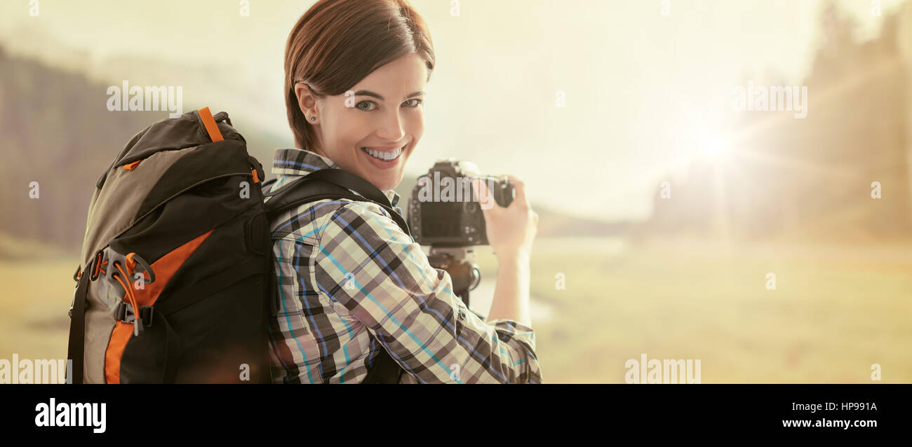 Professional hiker and photographer shooting in nature with a digital ...