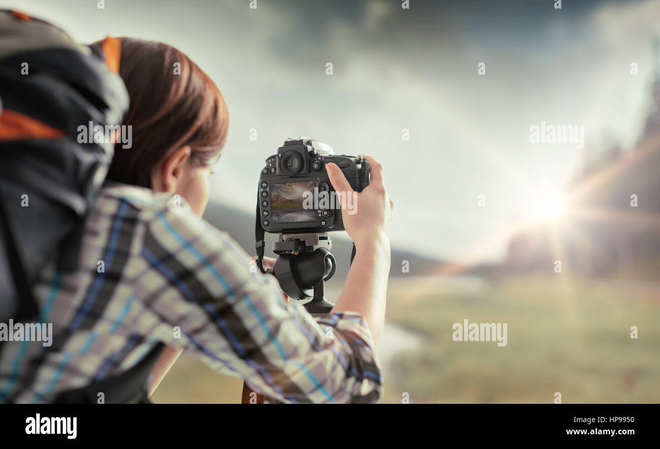 Professional hiker and photographer shooting in nature with a digital ...