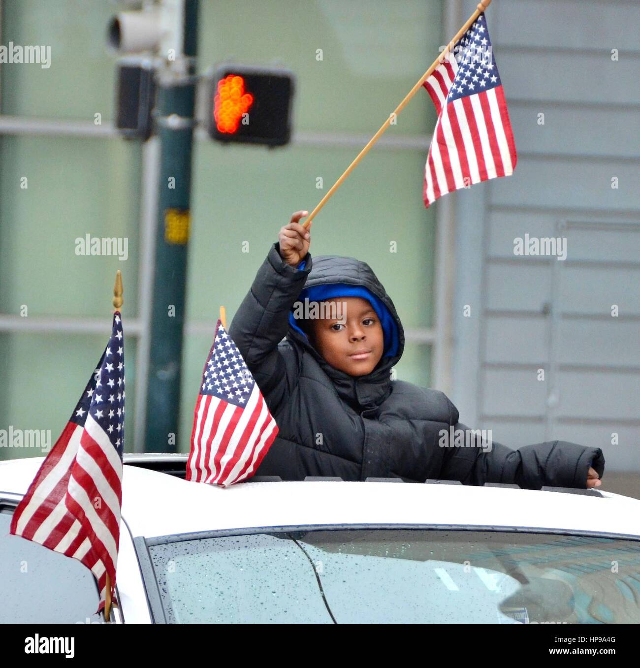 Unidentified young African American child waving an American Flag while ...