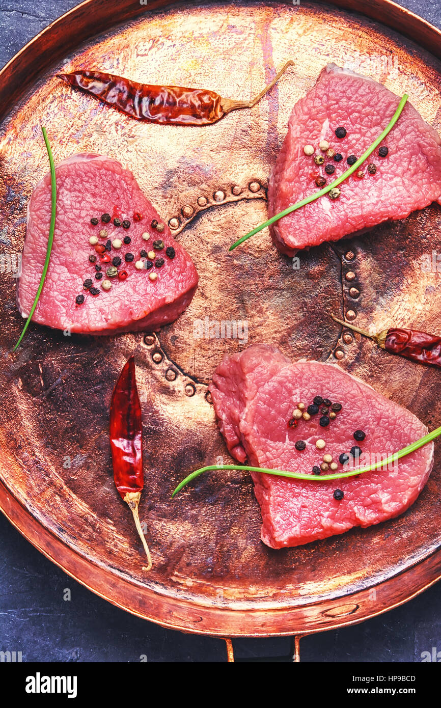 fillet of beef in spices, vintage copper pan Stock Photo - Alamy