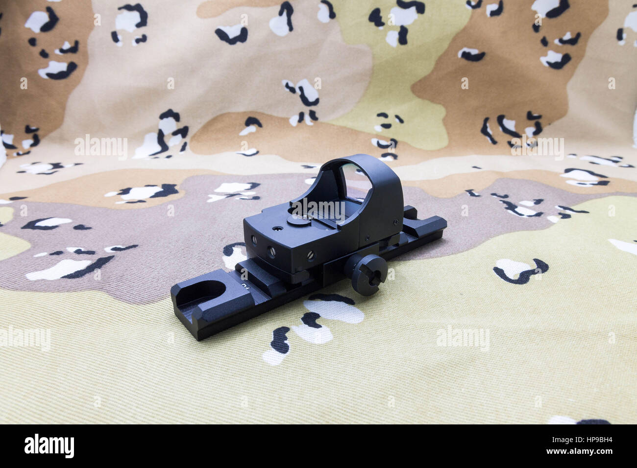 Reflex Sight on the sandy camouflage. The sight on the tracks Stock ...