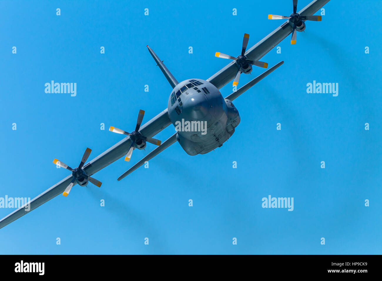 Military aircraft four engine propellor carrier flying low pass summers ...