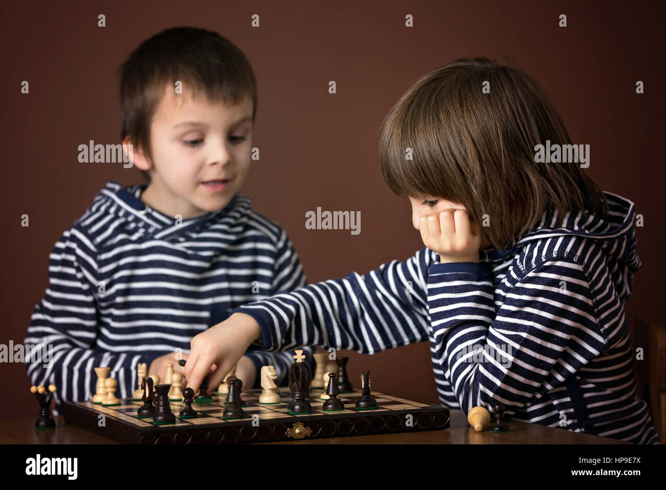 Little boy, playing chess. Smart kid, isolated, playing chess agains ...
