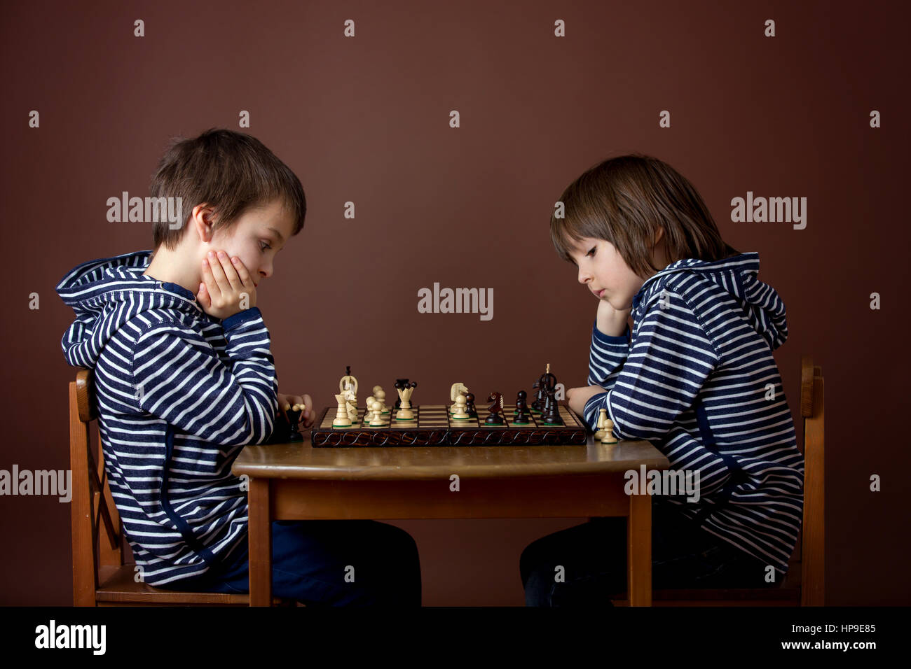Little boys, playing chess. Smart kid, isolated, playing chess agains ...