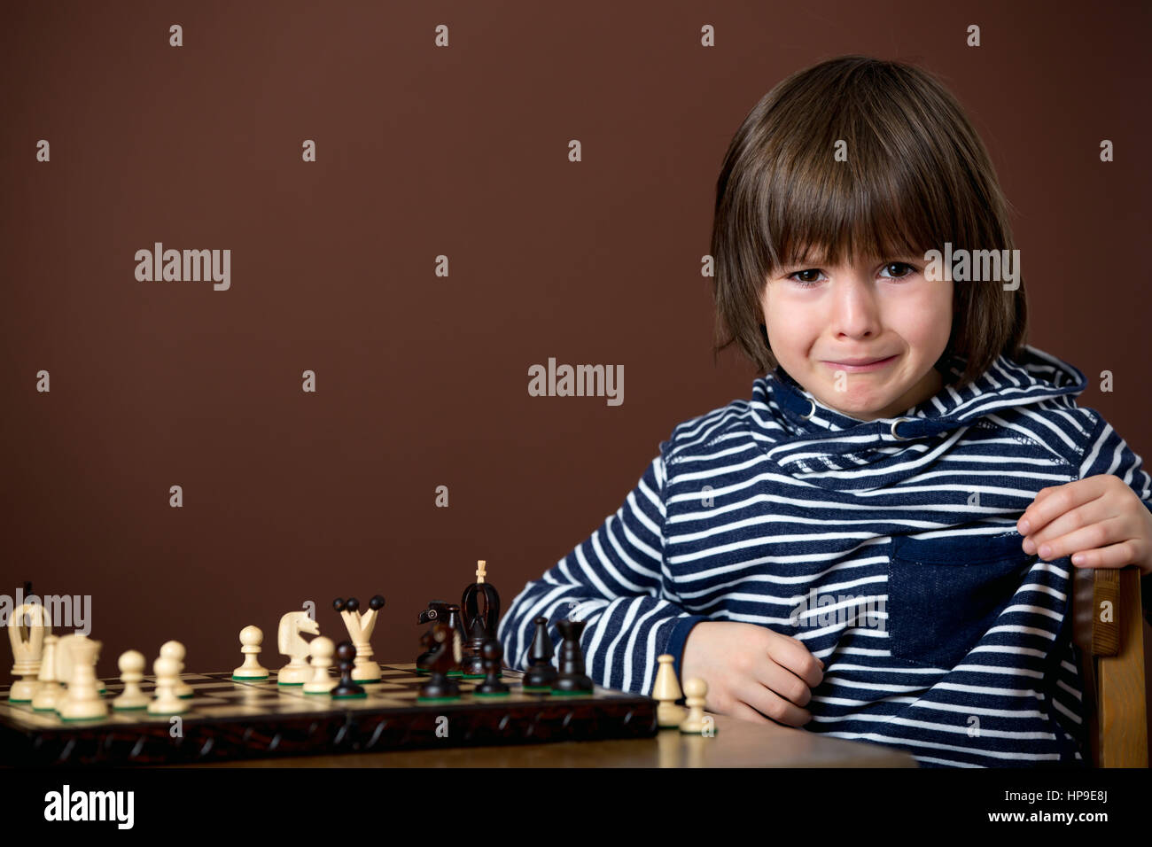 Little boy, playing chess. Smart kid, isolated, playing chess. Children ...