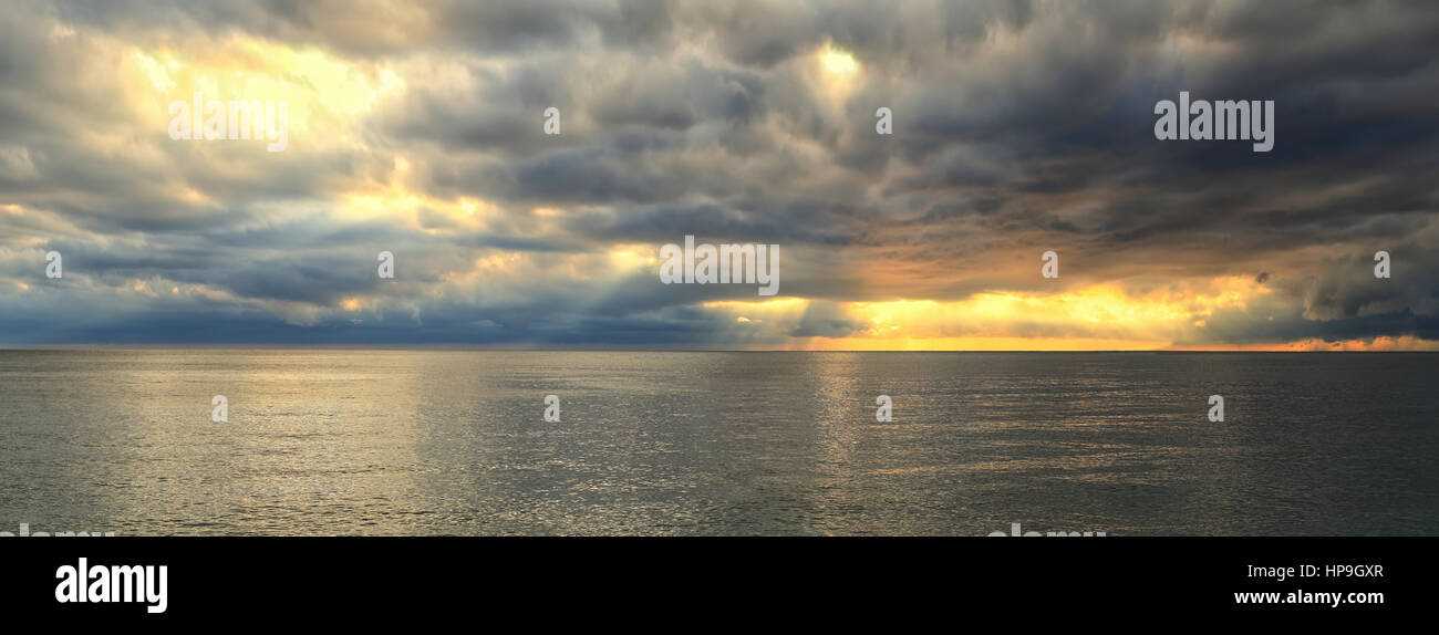 Evening with color clouds on the ocean Stock Photo - Alamy
