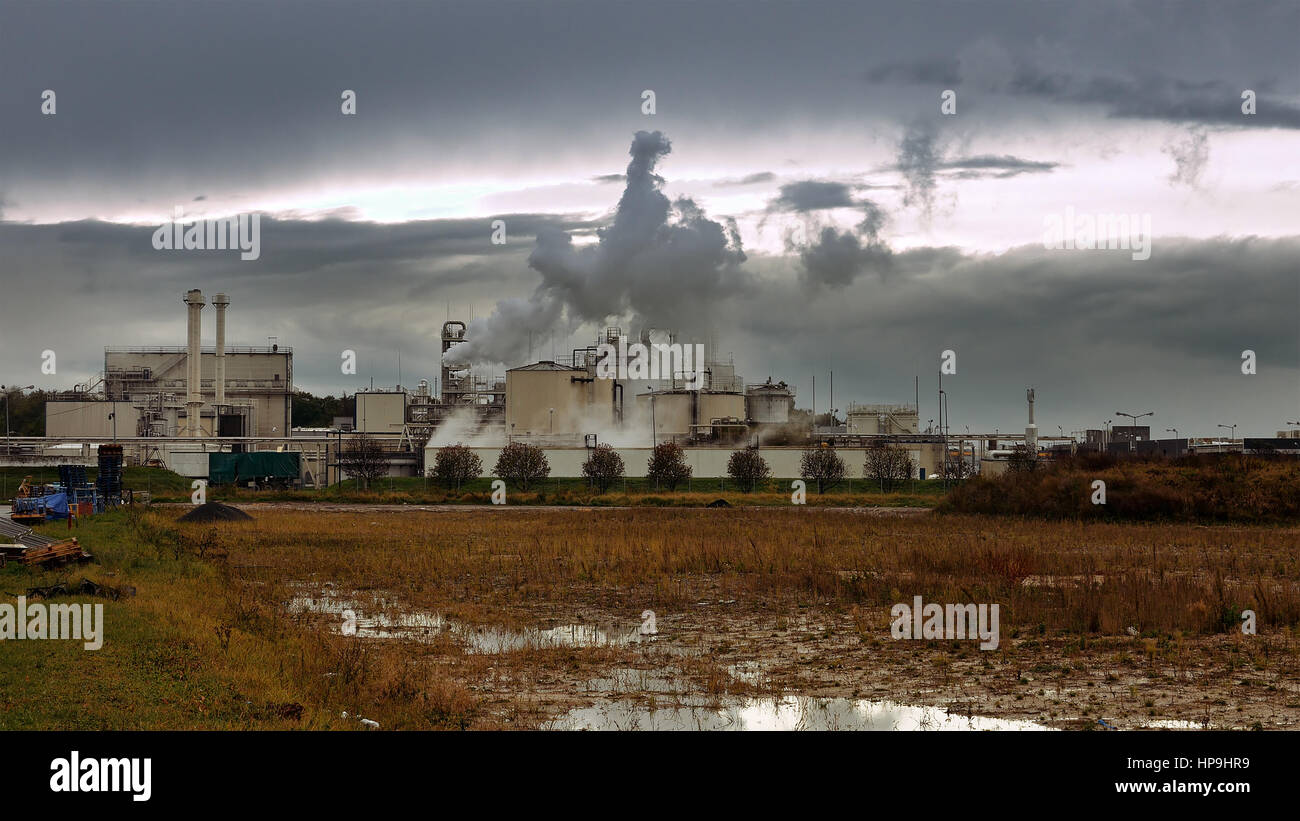 Factory smoke stack and pipes puff into air Stock Photo - Alamy