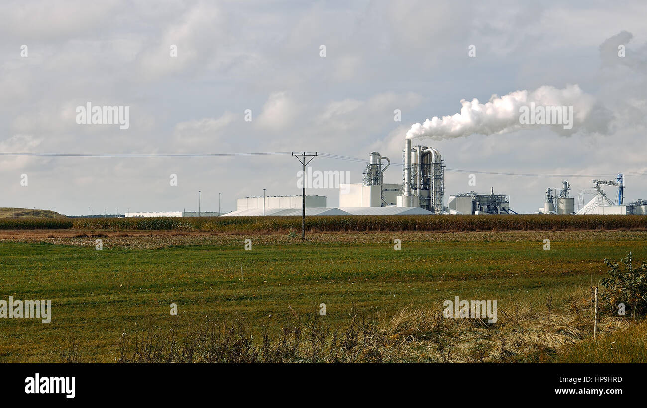 Factory smoke stack and pipes puff into air Stock Photo - Alamy