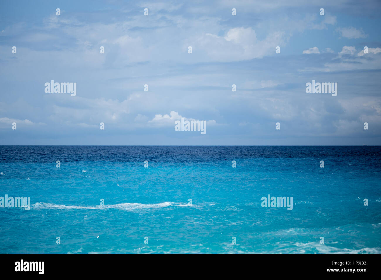 Sea with turquoise and deep blue color gradient blue sky and some ...