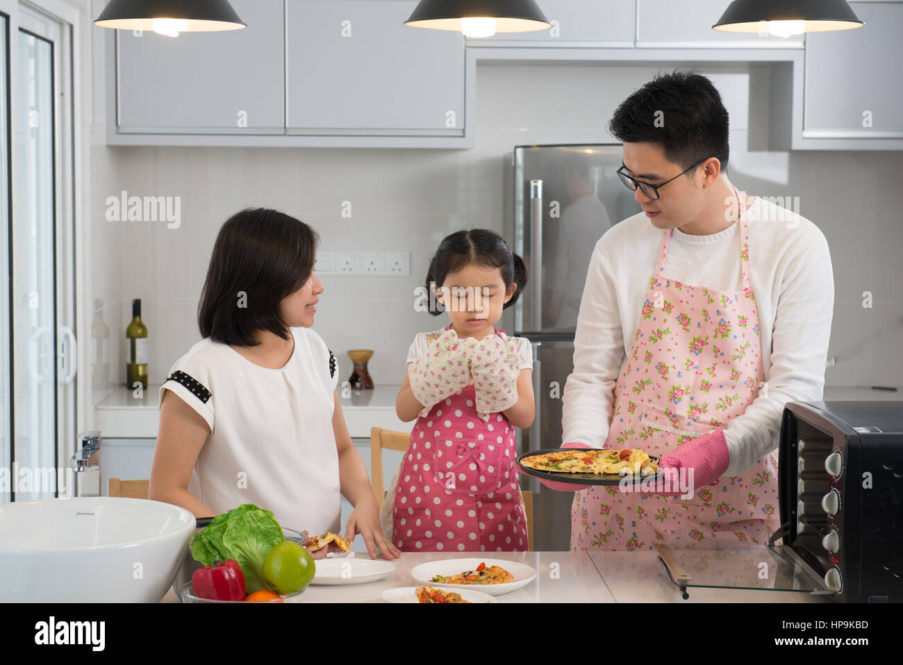 Asian family enjoying cooking pizza hi-res stock photography and images ...