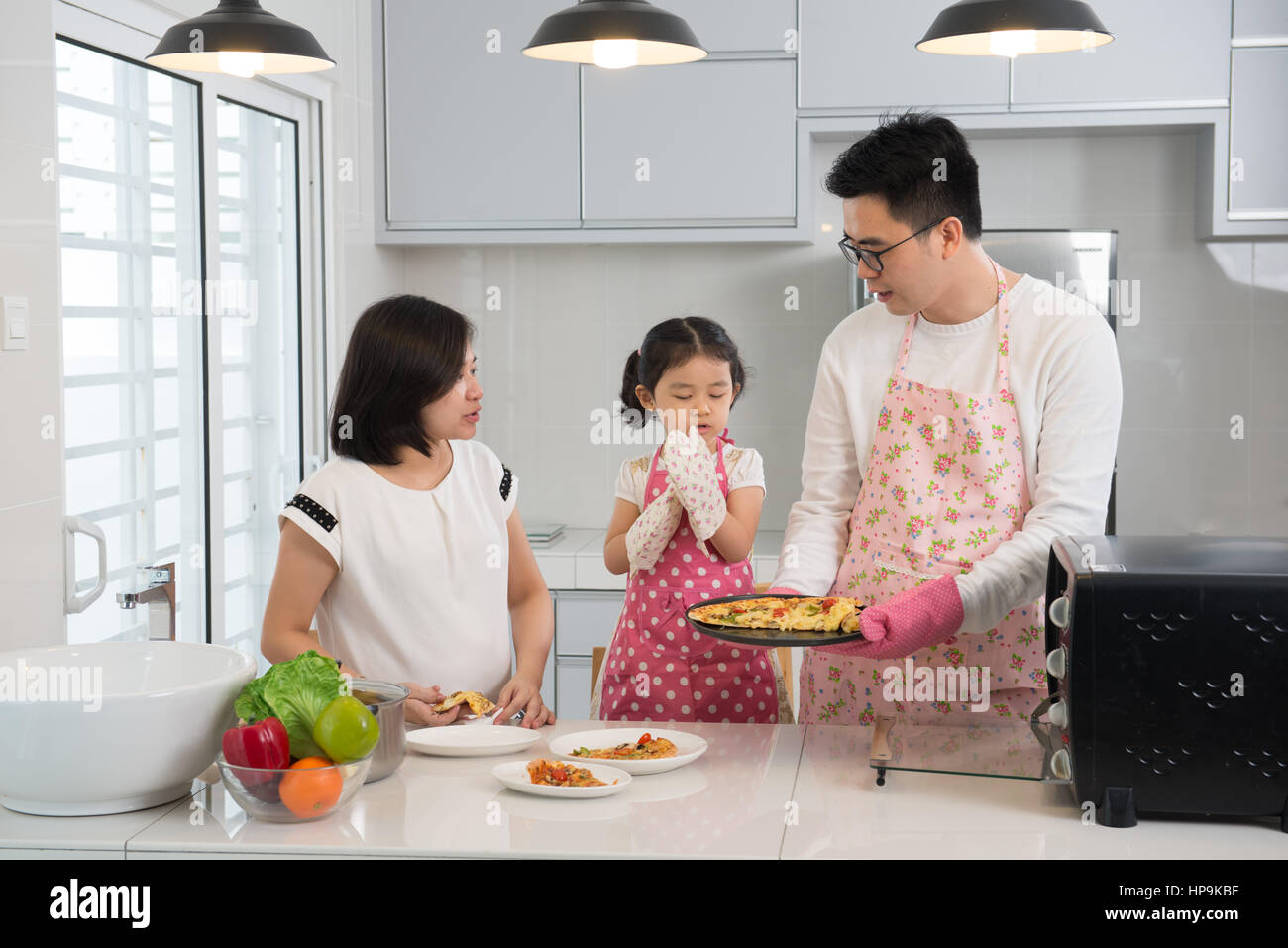 Asian family enjoying cooking pizza hi-res stock photography and images ...