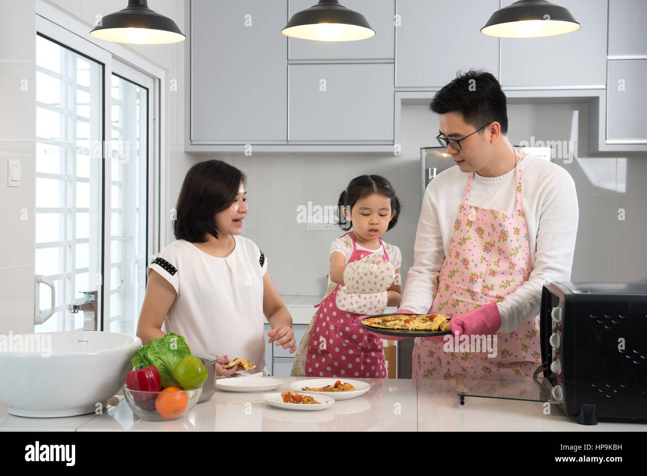 asian family enjoying and cooking pizza Stock Photo - Alamy