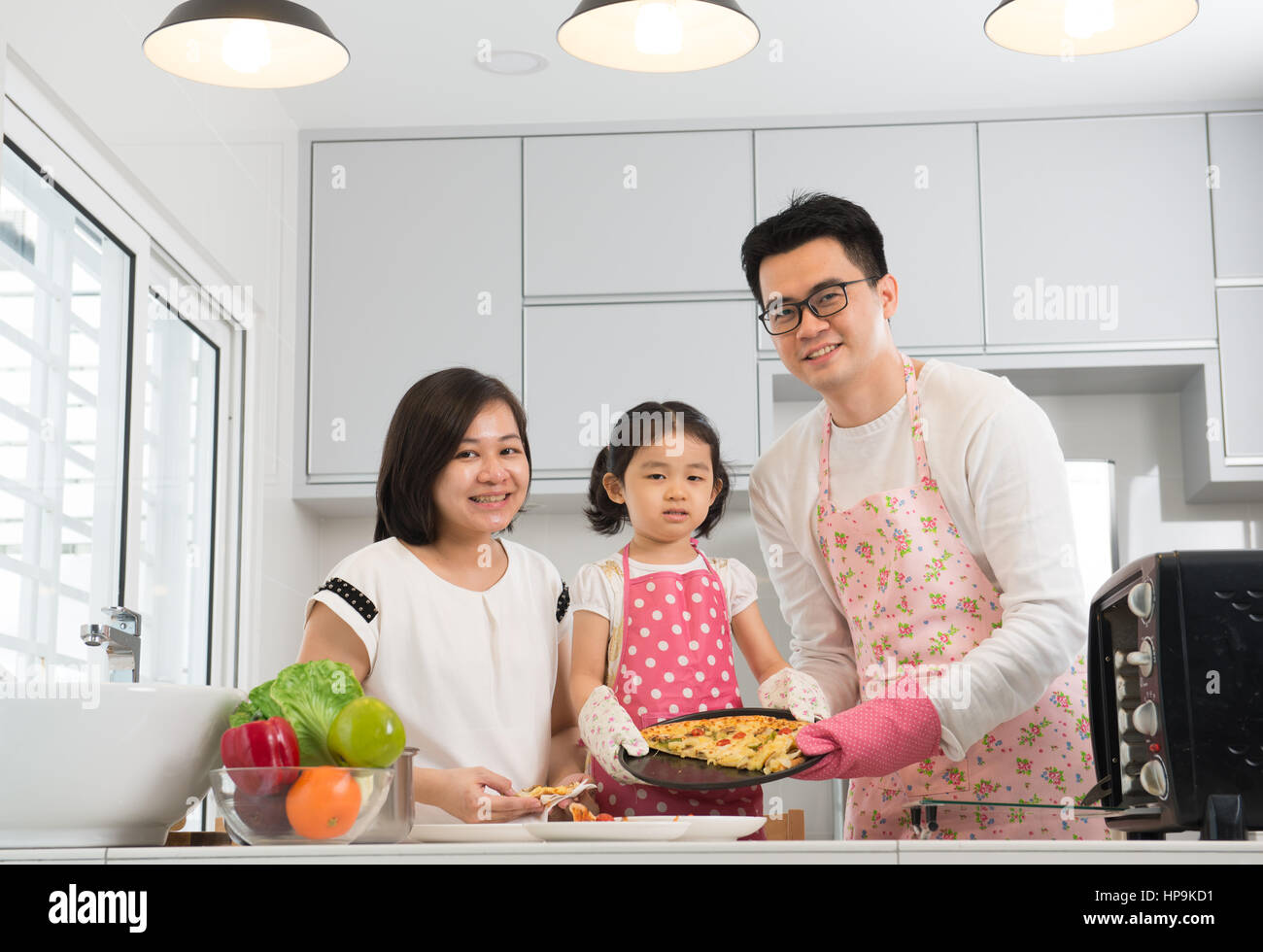 Asian family enjoying cooking pizza hi-res stock photography and images ...