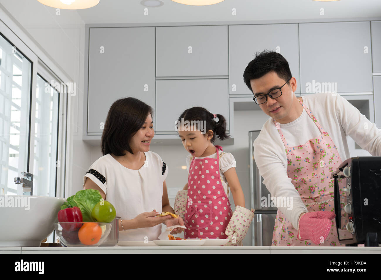 Asian family enjoying cooking pizza hi-res stock photography and images ...