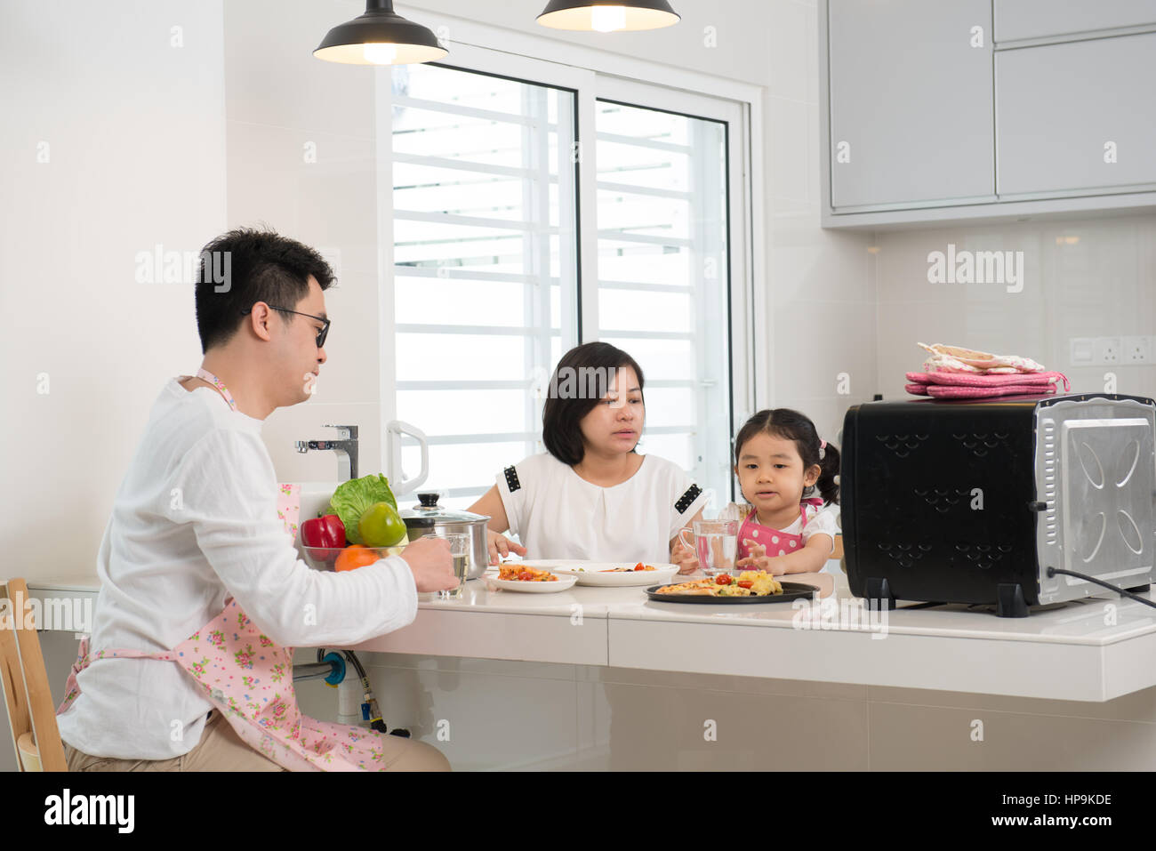 Asian family enjoying cooking pizza hi-res stock photography and images ...