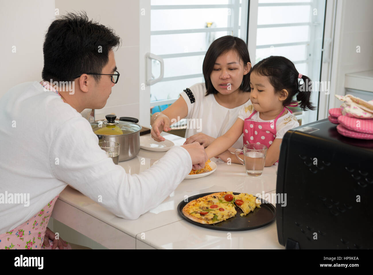 Asian family enjoying cooking pizza hi-res stock photography and images ...