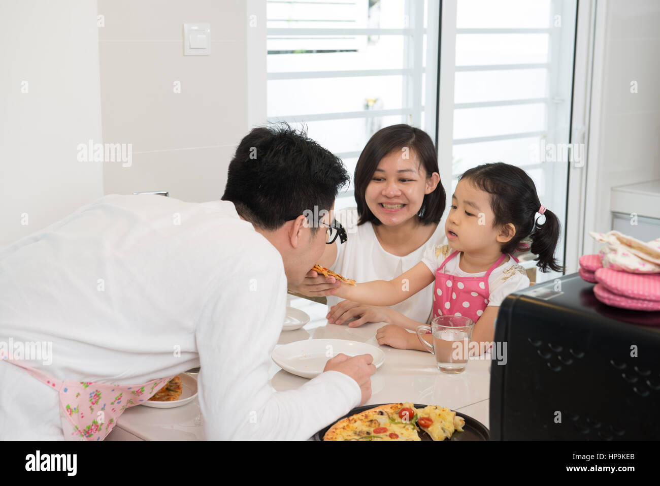 Asian family enjoying cooking pizza hi-res stock photography and images ...