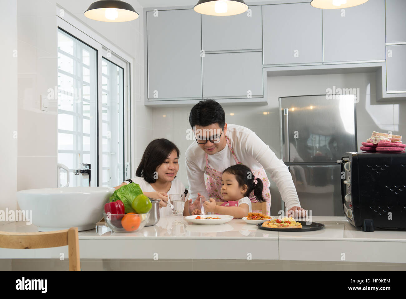 Asian family enjoying cooking pizza hi-res stock photography and images ...