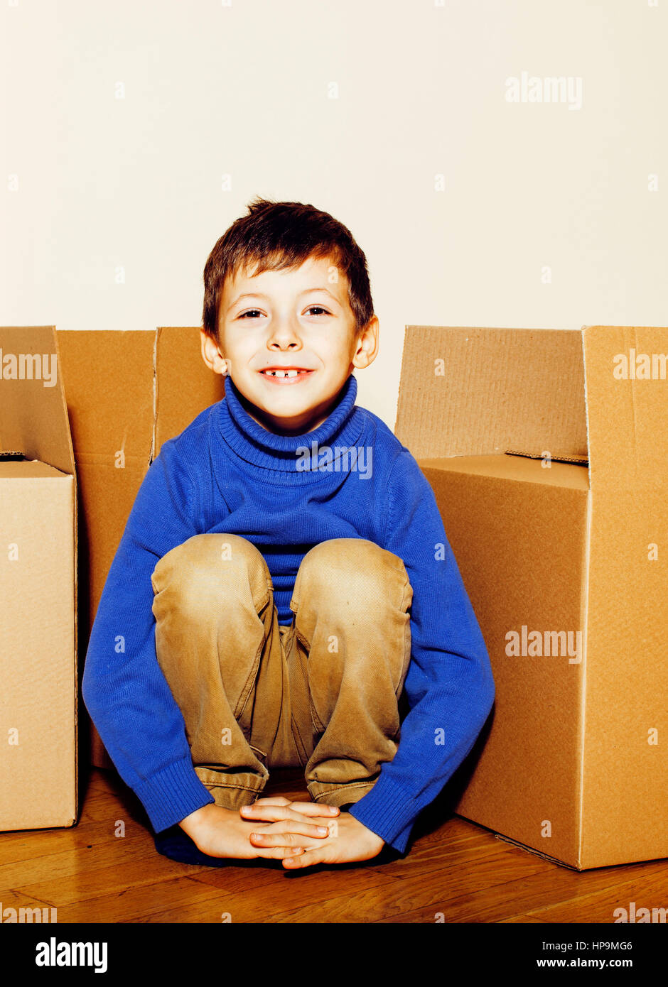 little cute boy in empty room, remoove to new house. home alone emong ...