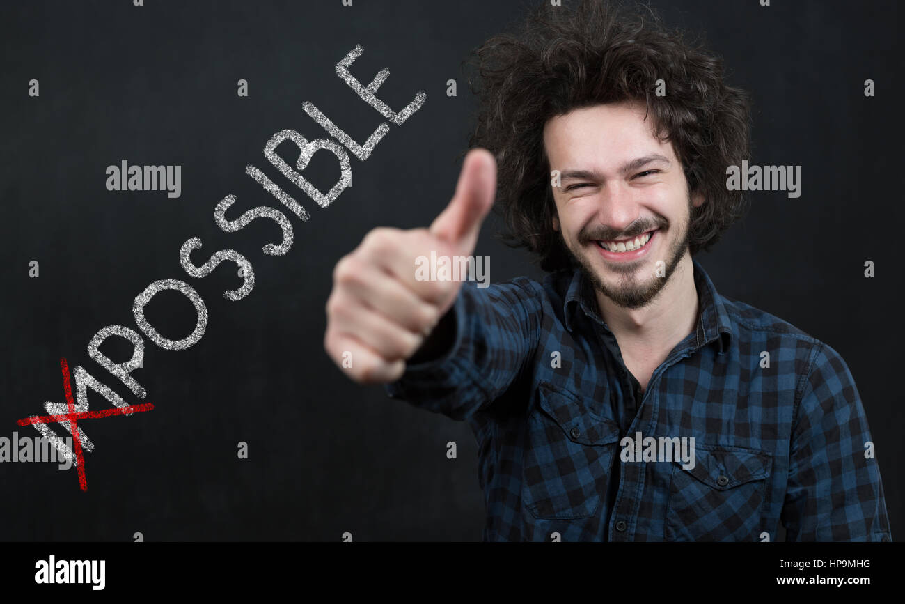 Portrait of man with Impossible text write on black board Stock Photo ...
