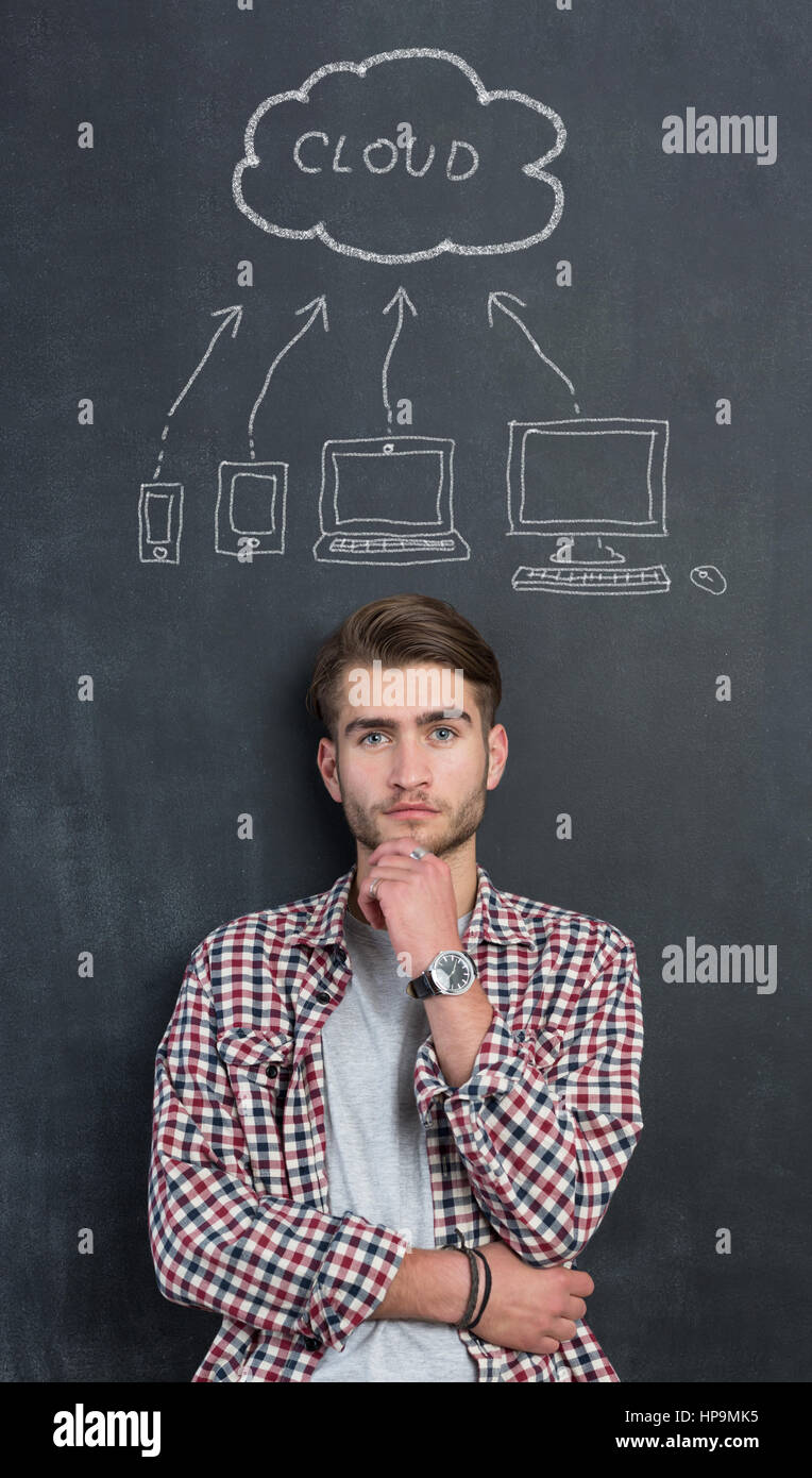 Portrait of man with cloud computing diagram on the chalkboard. Cloud ...