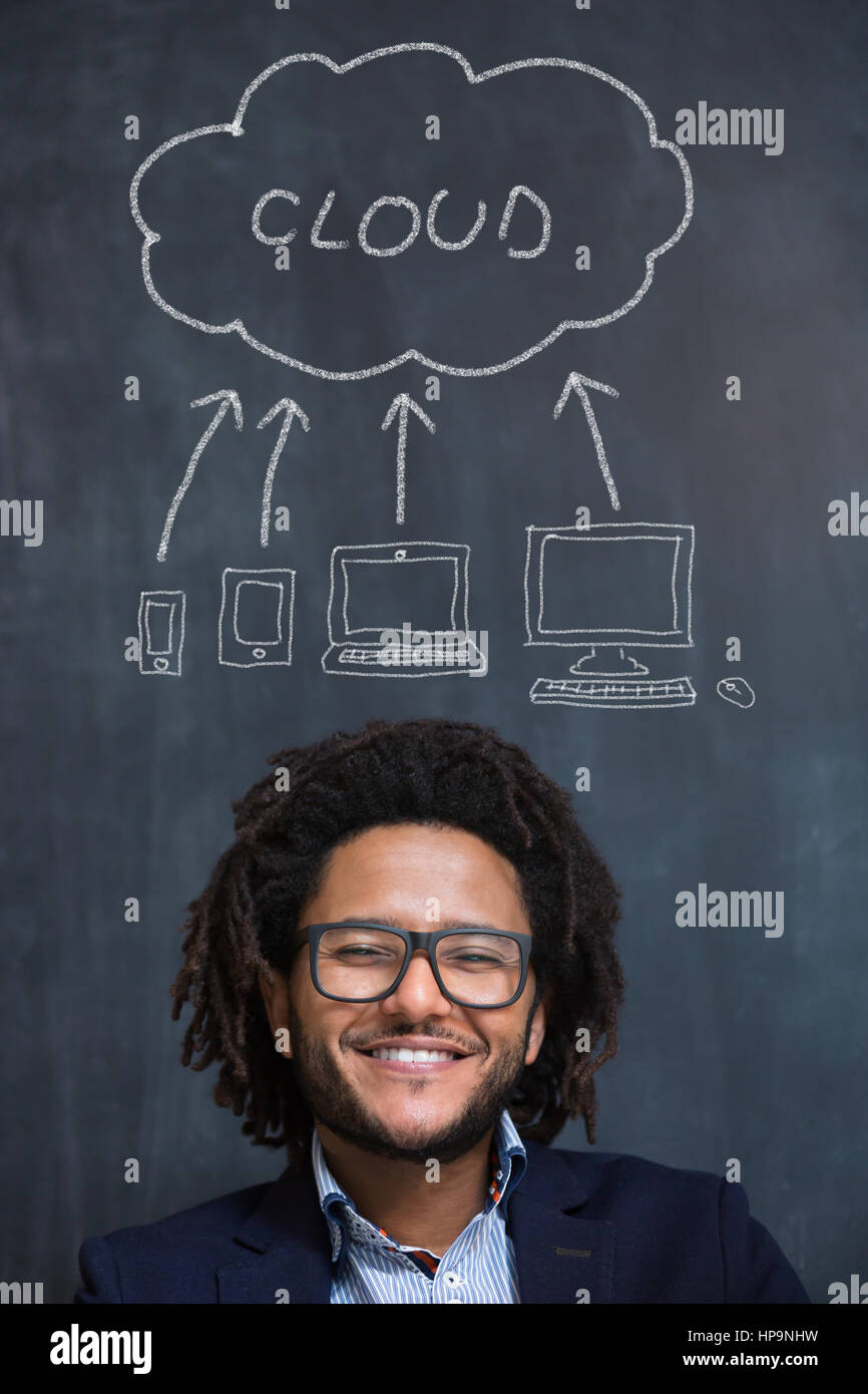 Portrait of man with cloud computing diagram on the chalkboard. Cloud ...