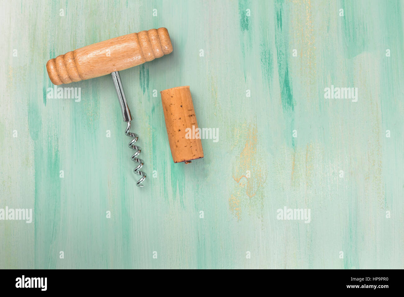 A photo of an old-fashioned corkscrew with a cork, shot from above on a ...