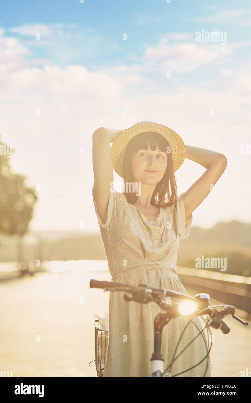 Young woman against nature background with bike Stock Photo - Alamy