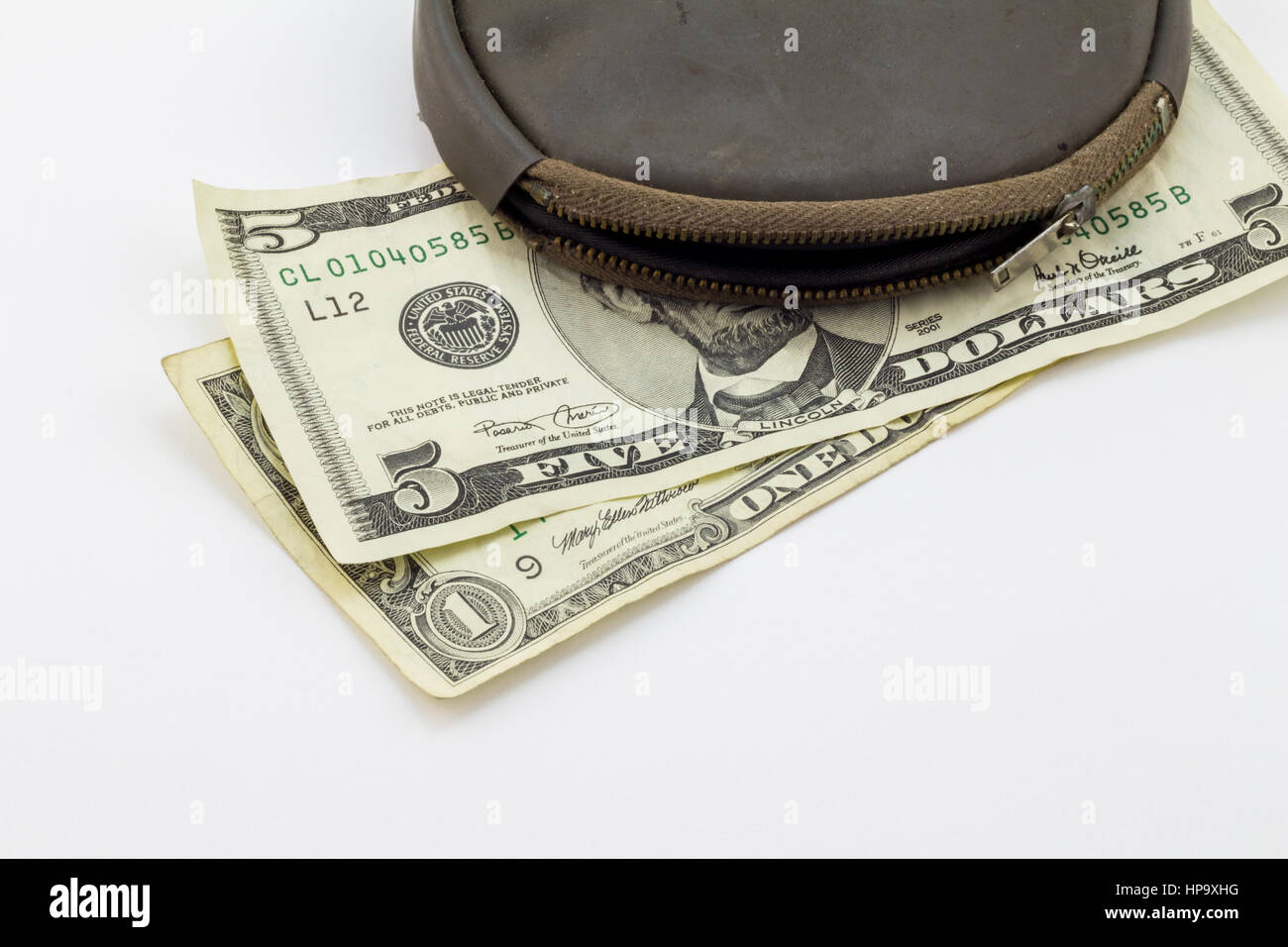 Worn empty wallet/purse with Five Dollar and One Dollar bills on white ...