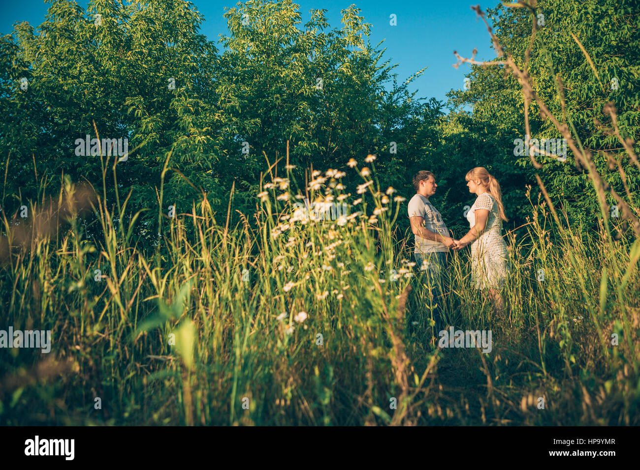 love story man and woman on the background of haystacks sun Stock Photo ...