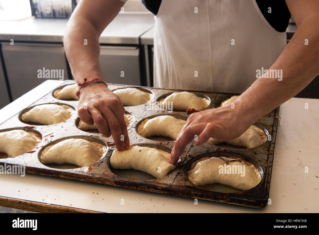 Close-up of cook hands making panzerotti, placing dough turnover on ...