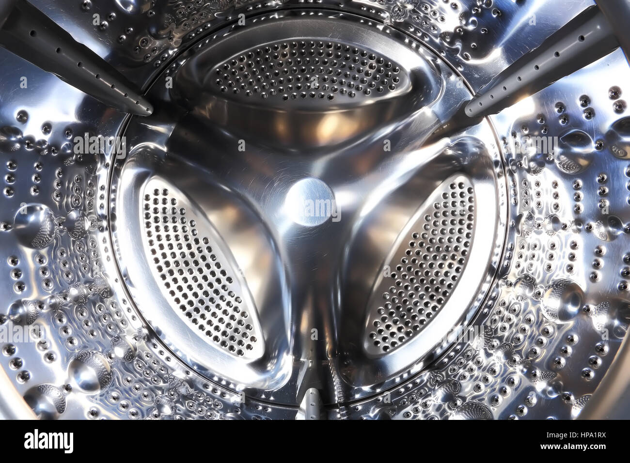 Washing machine inside. Shiny washing machine drum. Shiny steel ...