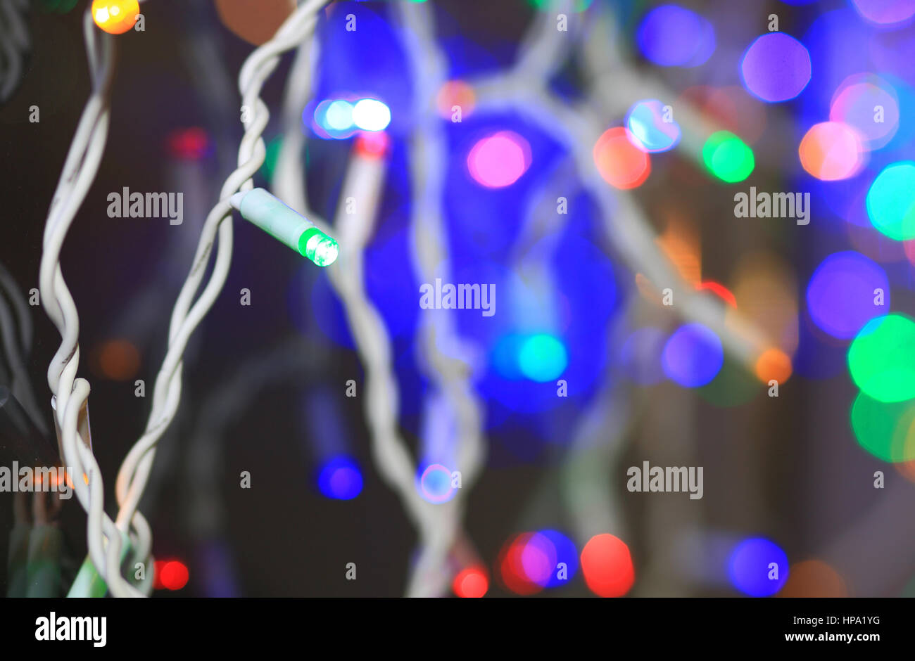 Electric celebration lights on blured color background. Color ...