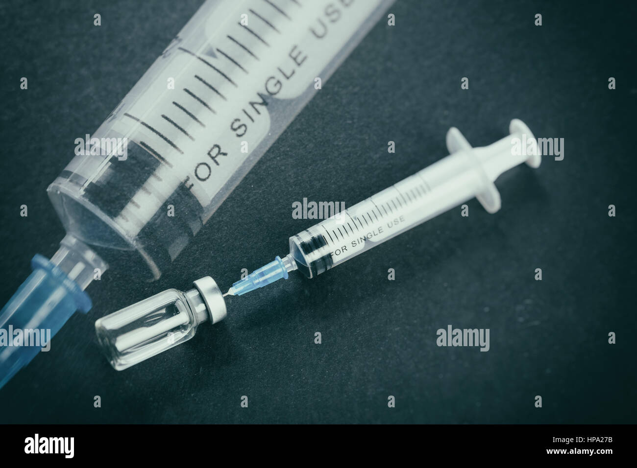 single use Medical syringe white dark background Stock Photo - Alamy