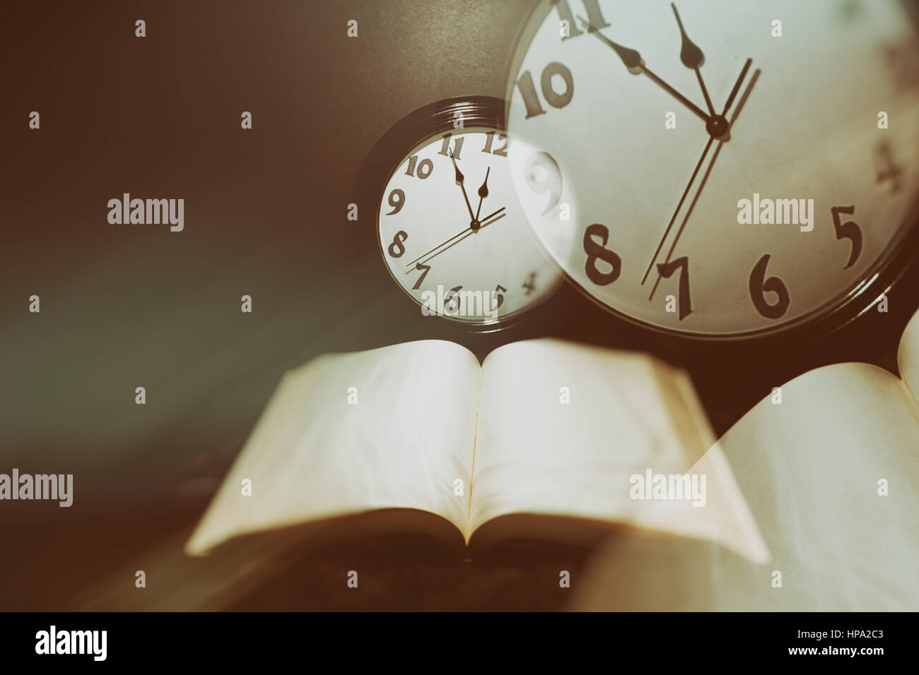 wall clock face and book, concept of time control Stock Photo - Alamy