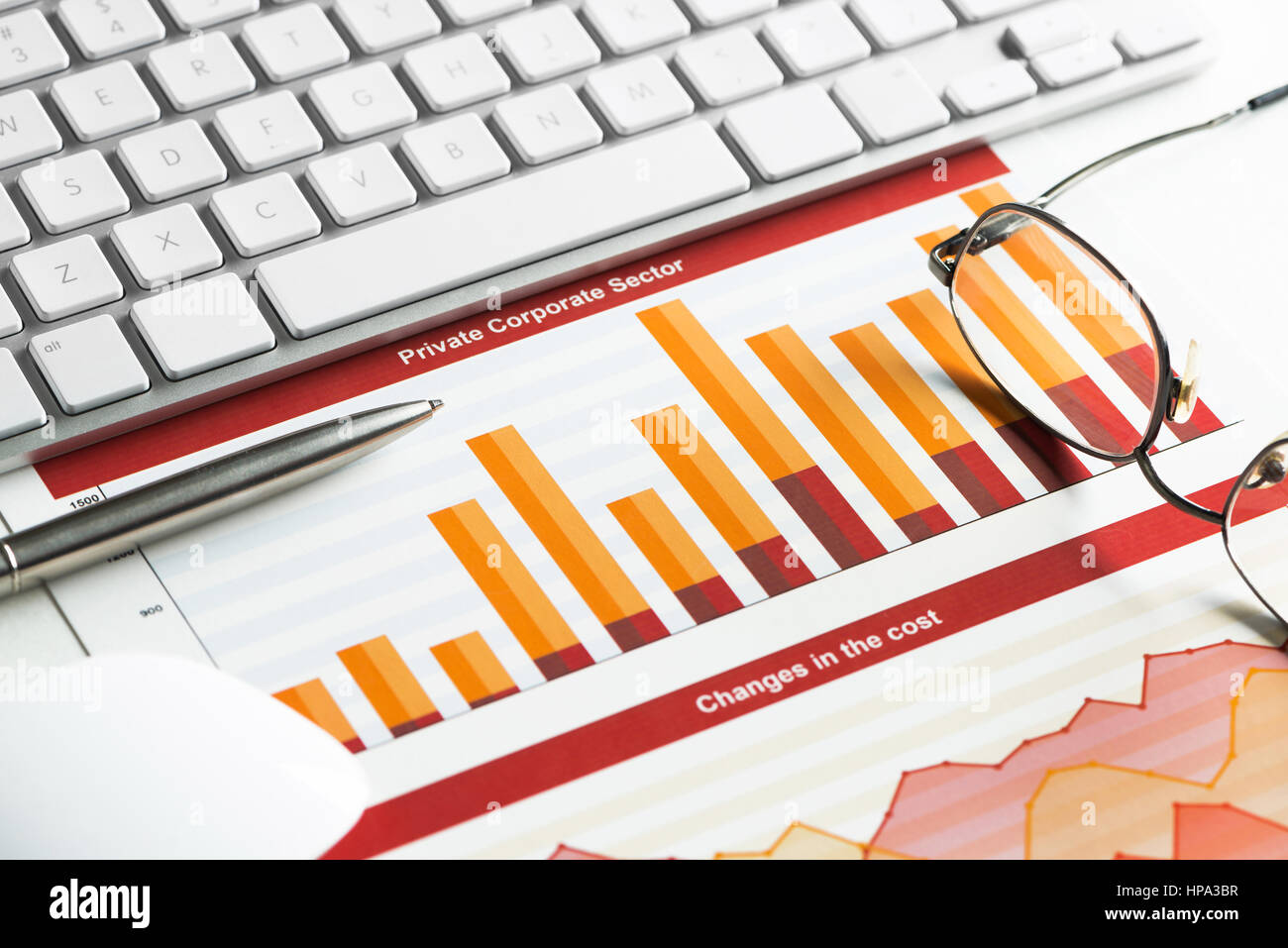 Business workplace with keyboard mouse and papers with graphs and ...