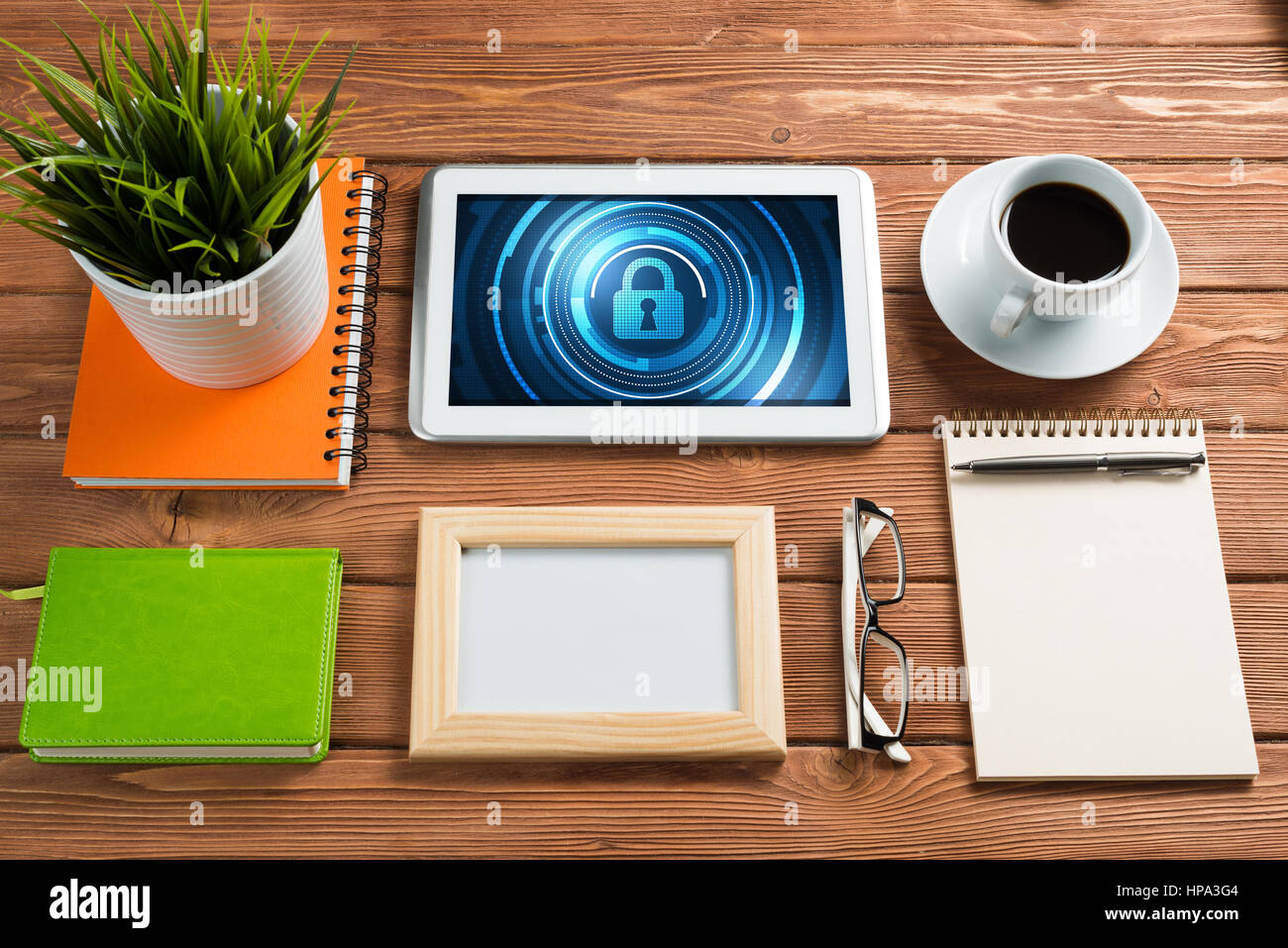 Business workplace with office stuff and tablet with padlock icons on ...