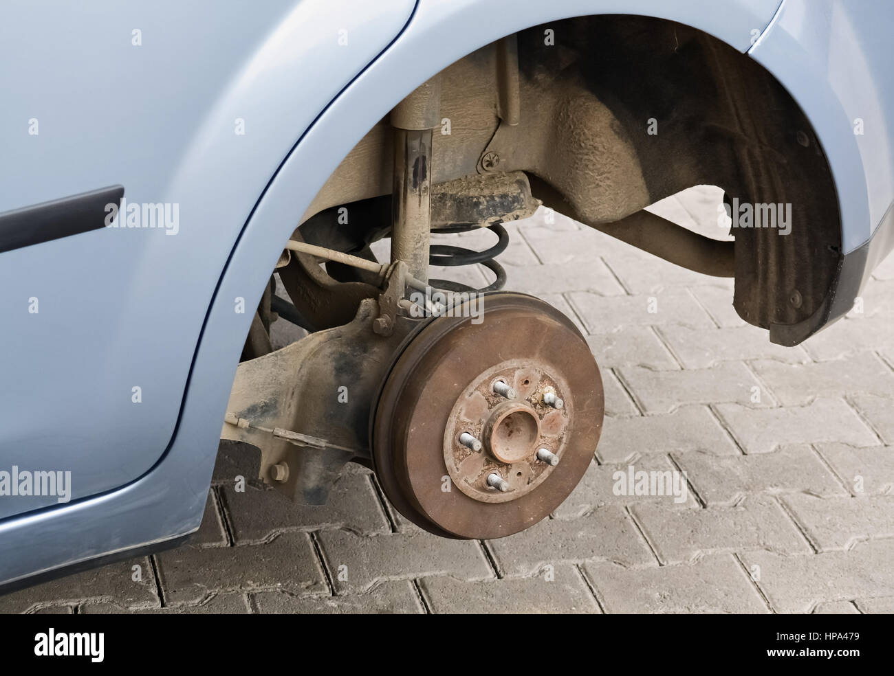 Closeup the disc of a car and disassembled wheel during the servicing ...