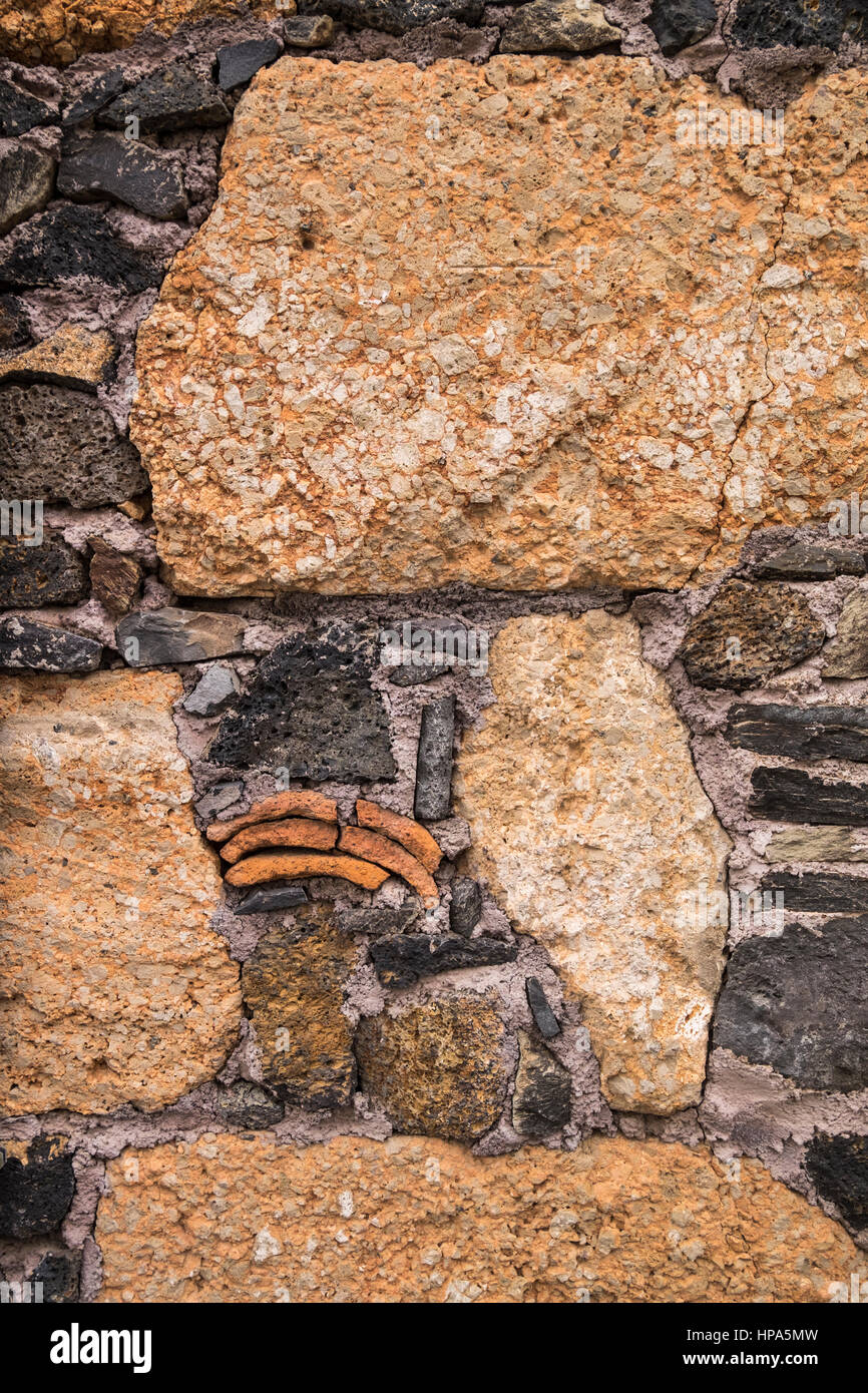 Detail of natural stone built wall with volcanic and conglomerate rock ...