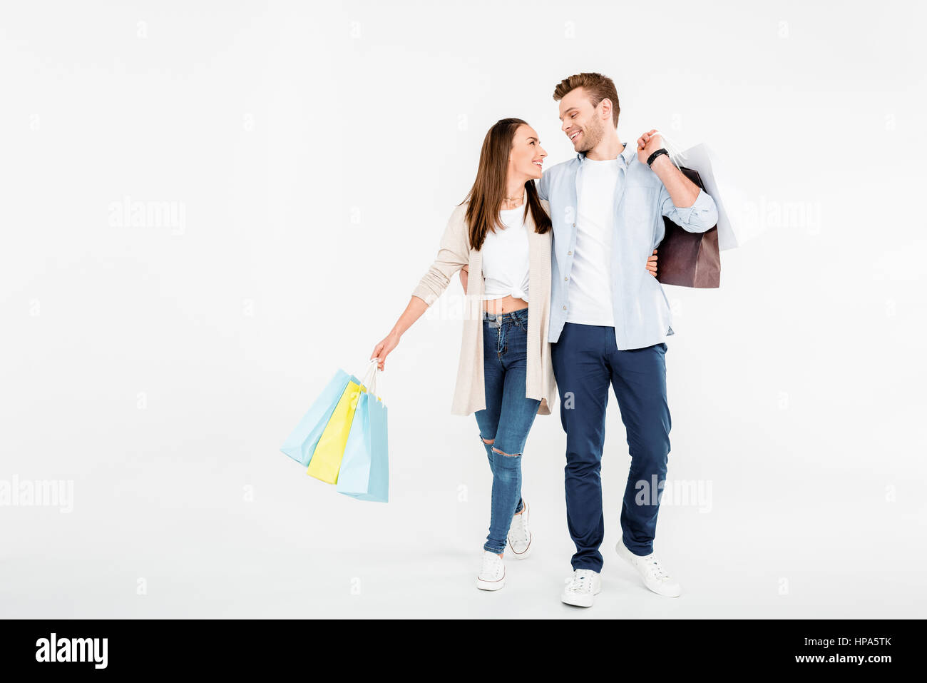 couple with shopping bags hugging and looking at each other Stock Photo ...