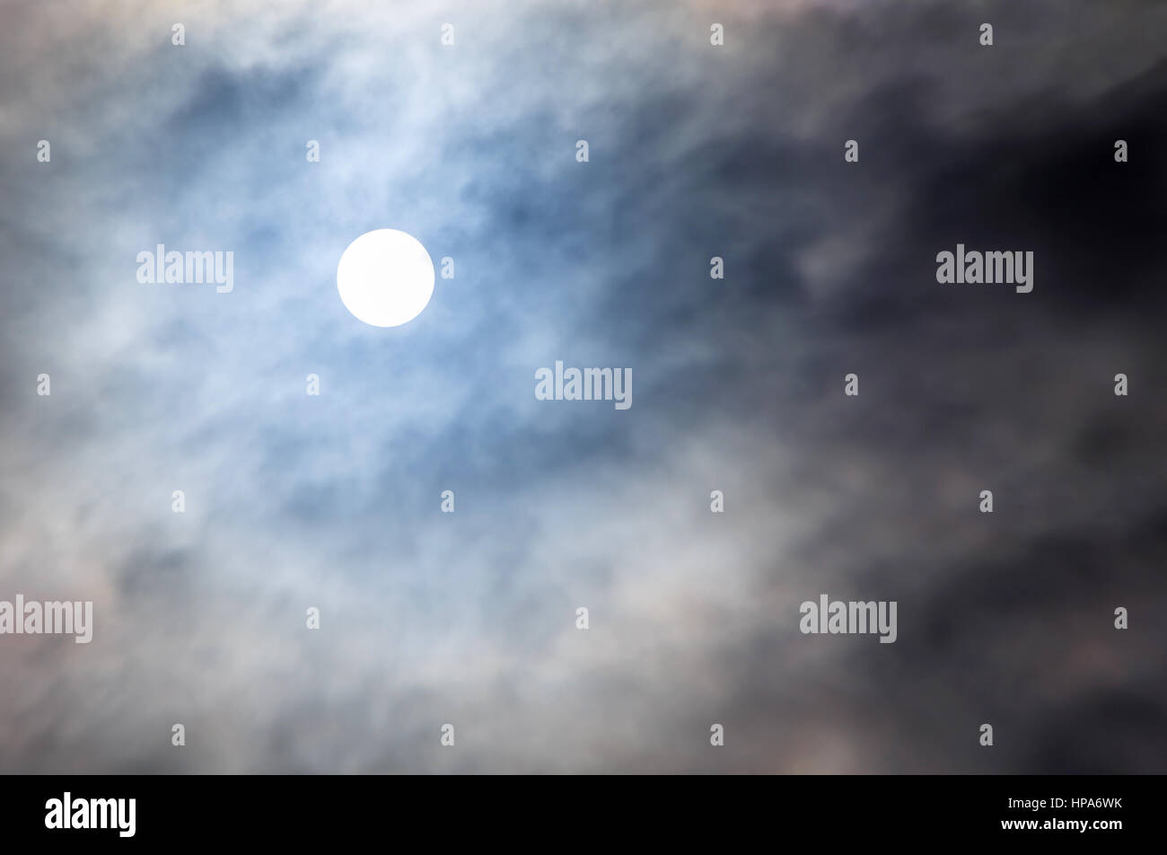 view on sun hidden behind clouds Stock Photo - Alamy