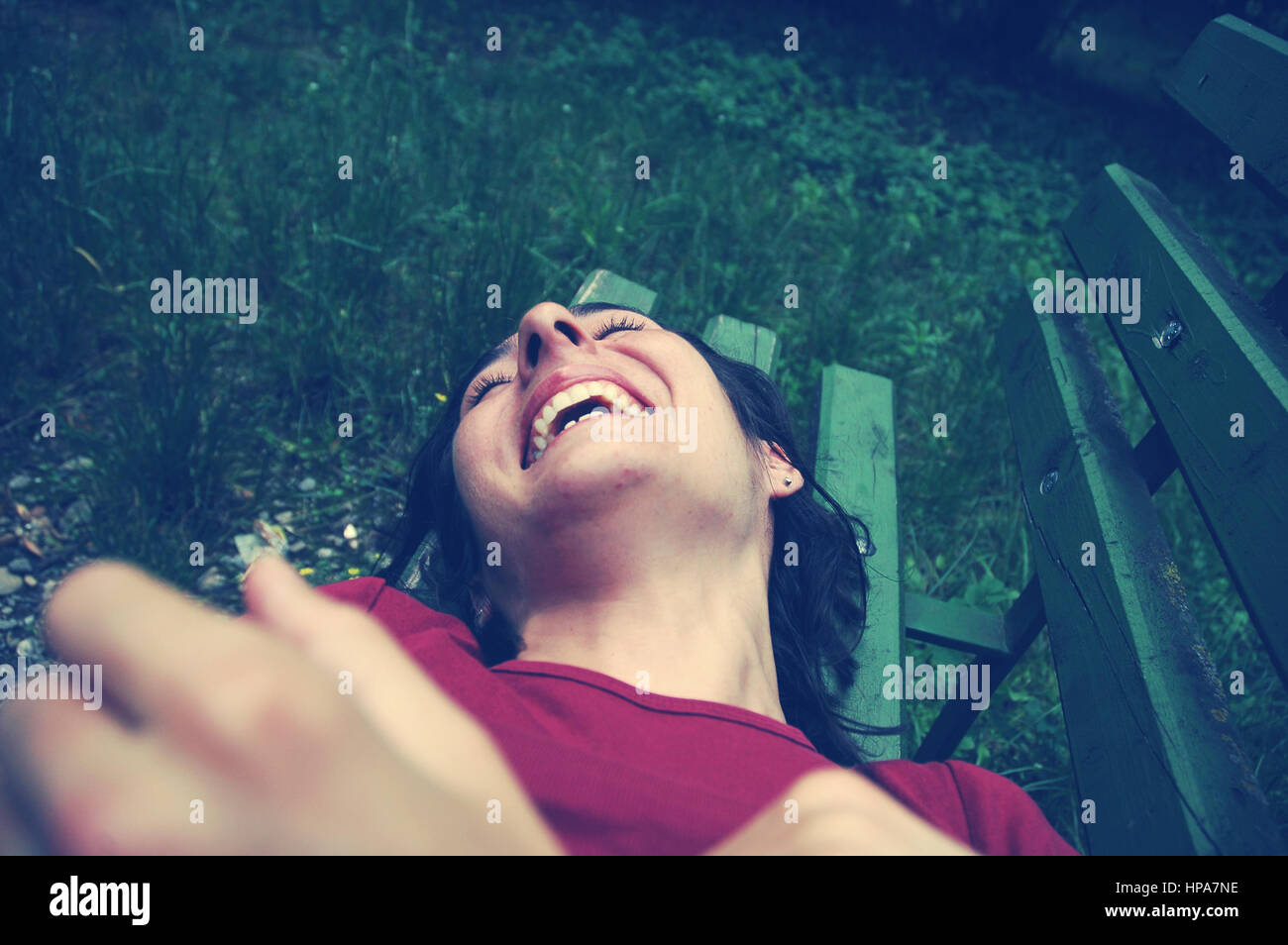 Tickling, tickled woman laughing on a bench. Toned image Stock Photo ...