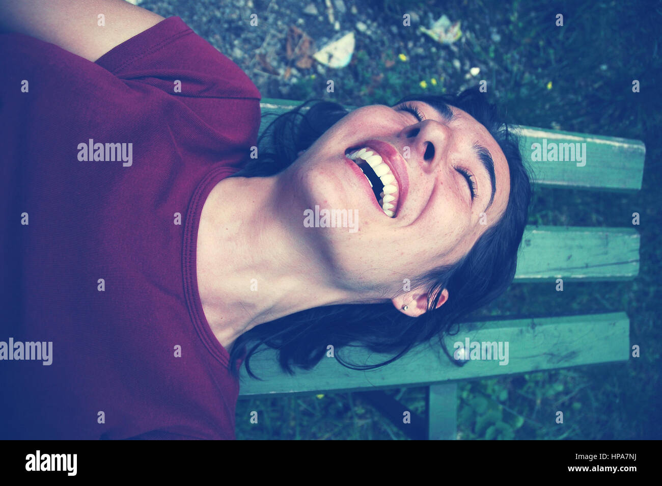 Tickling, tickled woman laughing on a bench. Toned image Stock Photo ...