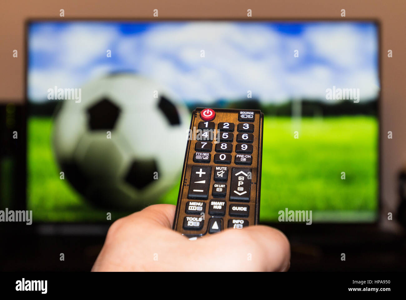 Watching soccer / football game on modern tv, with a close-up of the ...