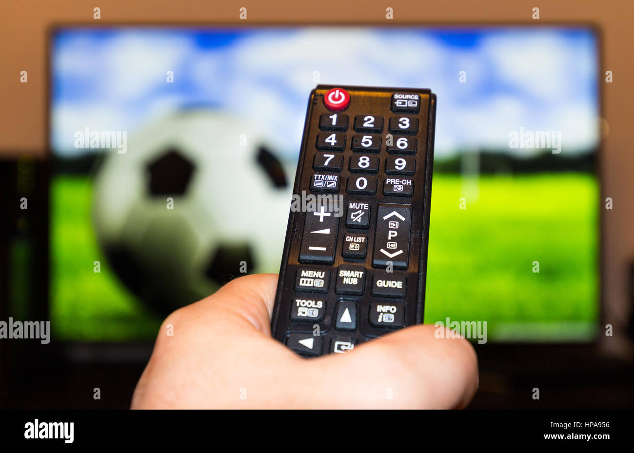 Watching soccer / football game on modern tv, with a close-up of the ...